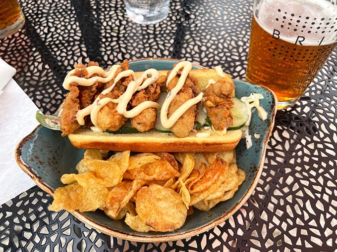 The Oyster Po' Boy: crispy fried oysters, house-made pickle, and a drizzle of sauce. Nothing poor about these rich flavors.