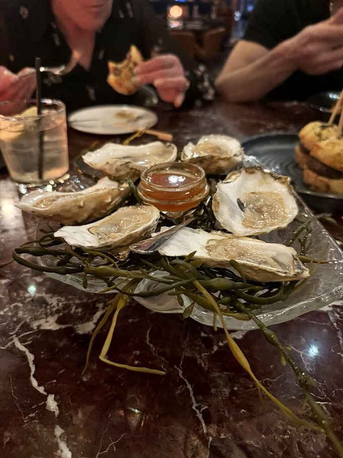 Fresh oysters nestled on seaweed&mdash;nature's perfect appetizer, requiring nothing more than a squeeze of citrus and a moment of gratitude.