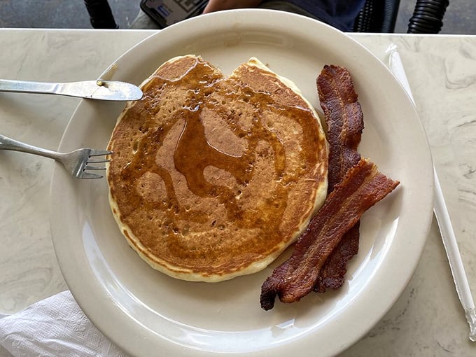 Breakfast's greatest hits album on a single plate&mdash;pancakes glistening with syrup and bacon so perfect it should come with its own theme music.