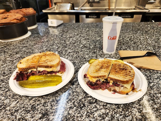 These aren't just sandwiches&mdash;they're architectural marvels of meat and bread. The pickle stands guard, ensuring no bite is without tang.
