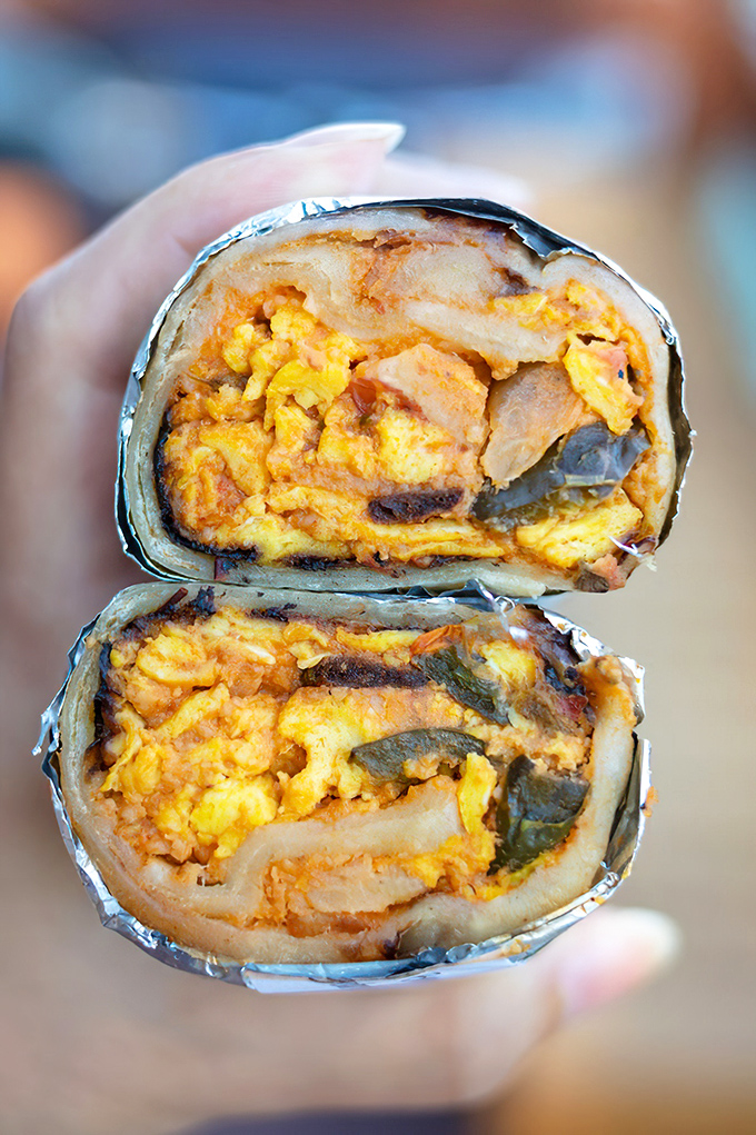 The vibrant filling almost glows with flavor intensity. Each bite delivers a perfectly balanced spice profile that dances across your taste buds.