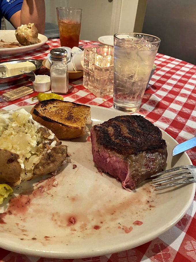 Cutting into this medium-rare masterpiece reveals the pink promise of steak perfection. The juice says it all.