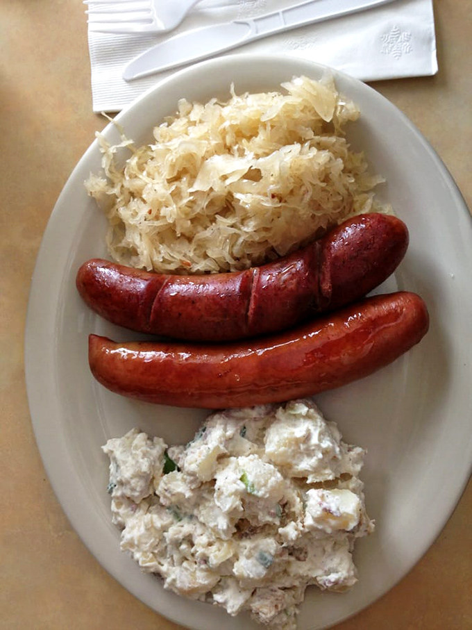 Red sausages nestled against golden sauerkraut and creamy potato salad&mdash;a plate that would make any Oma nod in approval. 