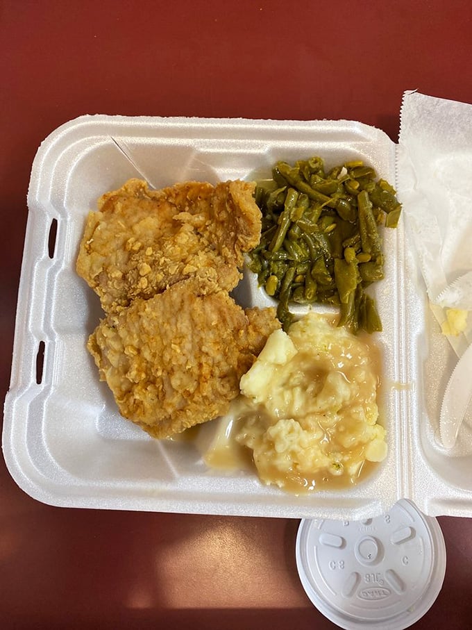 Simple fried pork chop with perfectly cooked green beans and those legendary mashed potatoes—a plate that would make your grandmother proud.