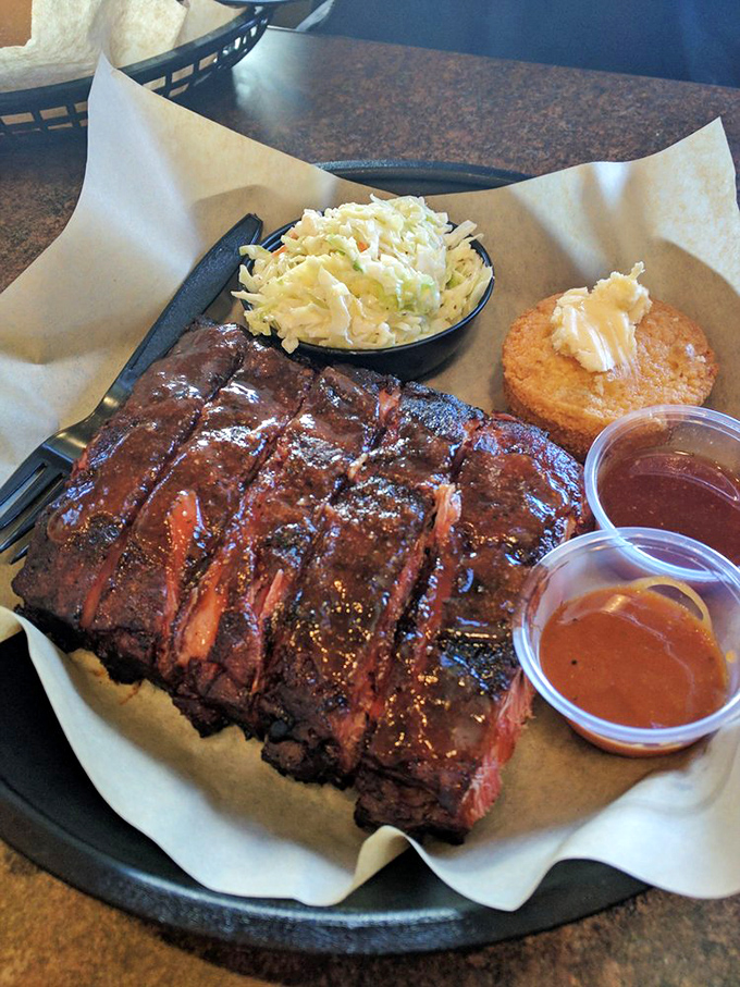 Pork ribs with that perfect pink smoke ring&mdash;the barbecue equivalent of finding a unicorn. The cornbread muffin stands by, ready for sauce-sopping duty. 