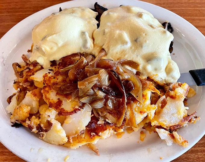 Eggs Benedict reimagined&mdash;where hollandaise cascades over potatoes like a golden waterfall. Comfort food that hugs you from the inside out.