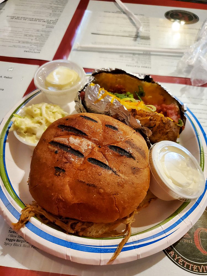 This pulled pork sandwich isn't just a meal; it's edible evidence that patience (hours of slow smoking) is indeed a virtue worth waiting for.