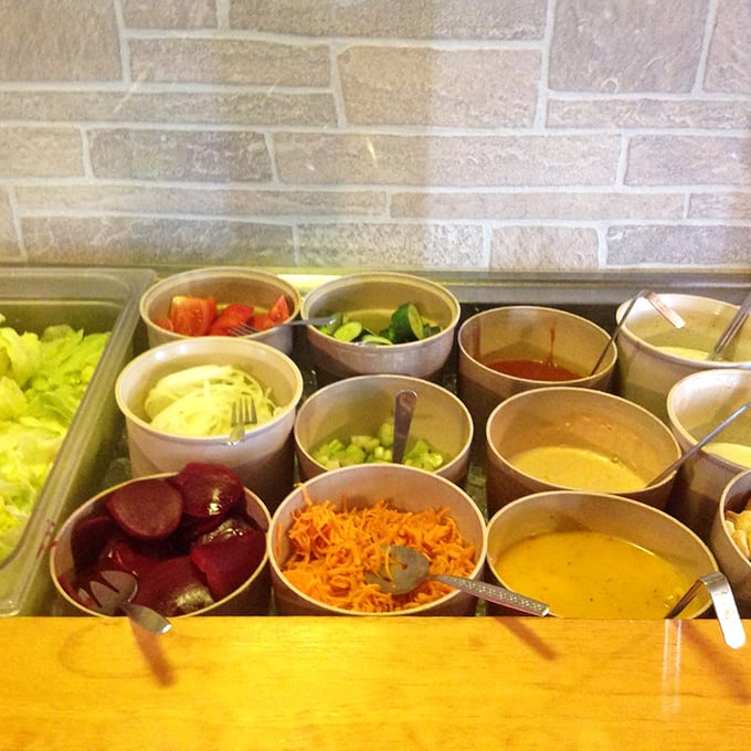 The salad bar's colorful array of fresh ingredients is like nature's jewelry box, waiting to accessorize your steak.