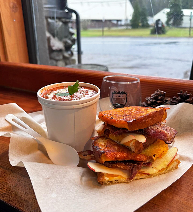A sausage sandwich that demands two hands and your full attention, with golden fries standing by for the inevitable encore performance. 