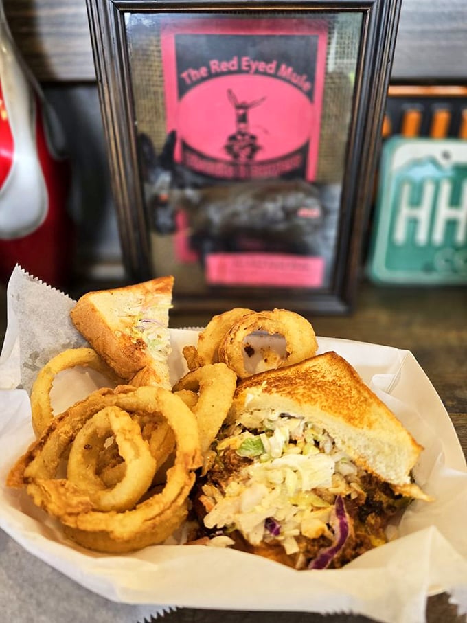 The onion rings form a golden moat around what appears to be the sandwich equivalent of a really good day wrapped in bread.