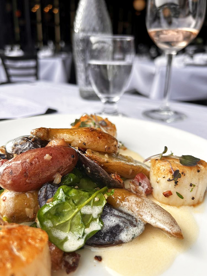 A plate that whispers "special occasion" while the potatoes and scallops perform a delicate dance of land and sea.