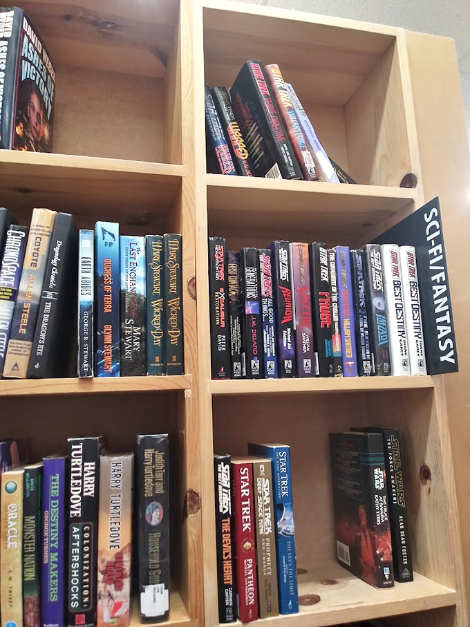 Science fiction books organized with NASA-like precision. Somewhere between these shelves is the answer to whether we're alone in the universe. 