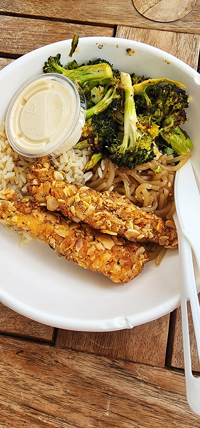 Almond-crusted chicken strips nestled alongside brown rice and sweet potato noodles&mdash;comfort food that somehow won't require comfort pants afterward.