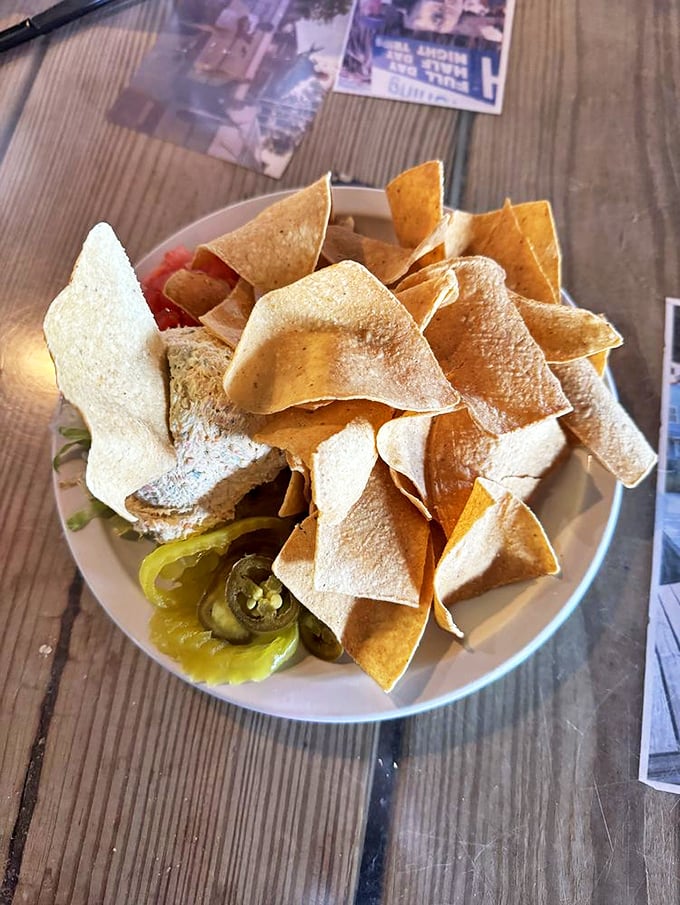 Tortilla chips surrounding a mystery dip&mdash;like a delicious archaeological dig where every scoop reveals another layer of flavor.