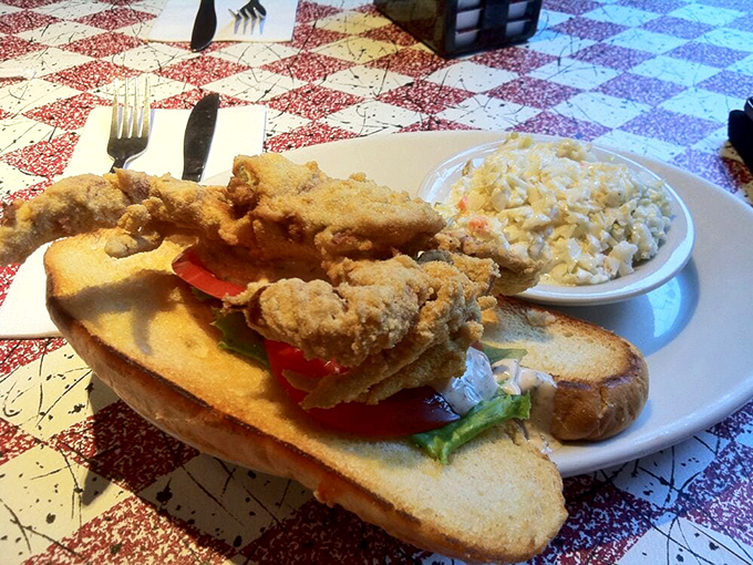 Not just a sandwich but an engineering marvel—crispy soft shell crab nestled between toast with enough height to require unhinging your jaw like a python.