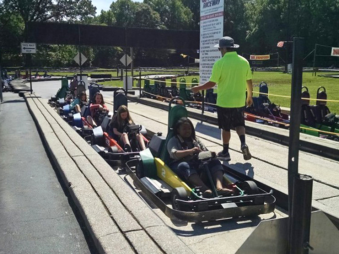 Staff in high-visibility shirts ensure safety while secretly judging your racing form. They've seen it all, from champions to chaos.