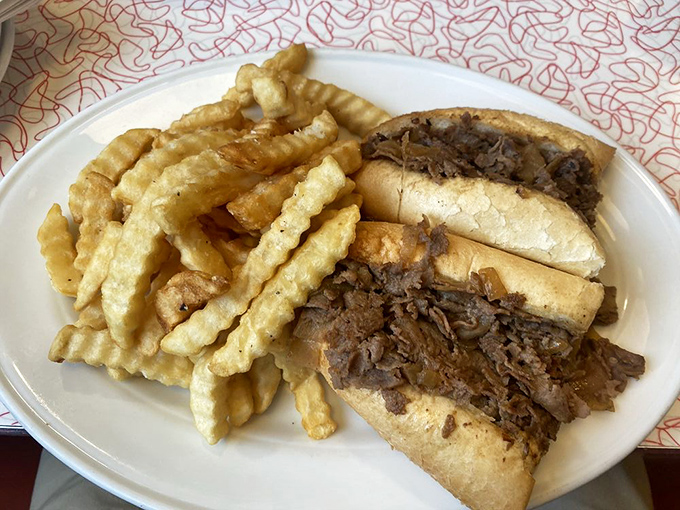 A steak sandwich that means business, paired with those crinkle-cut fries that somehow taste better than regular fries. Science can't explain it, but your taste buds don't care.