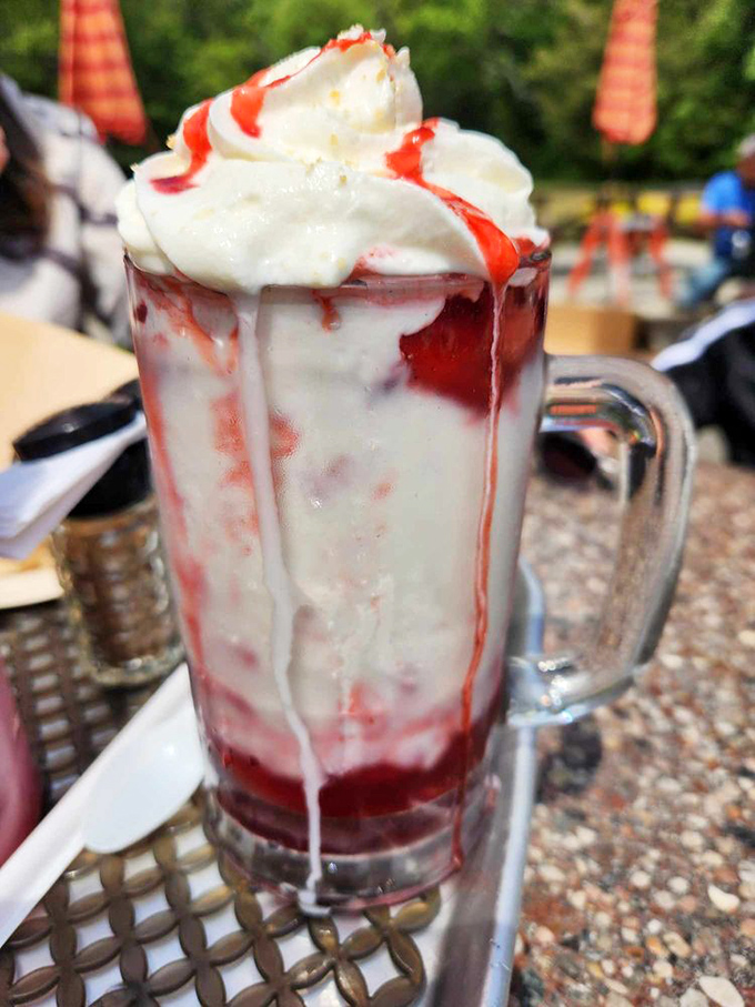 Strawberry shake decadence that defies gravity. This towering creation isn't just a dessert&mdash;it's an engineering marvel of ice cream, syrup, and whipped cream.
