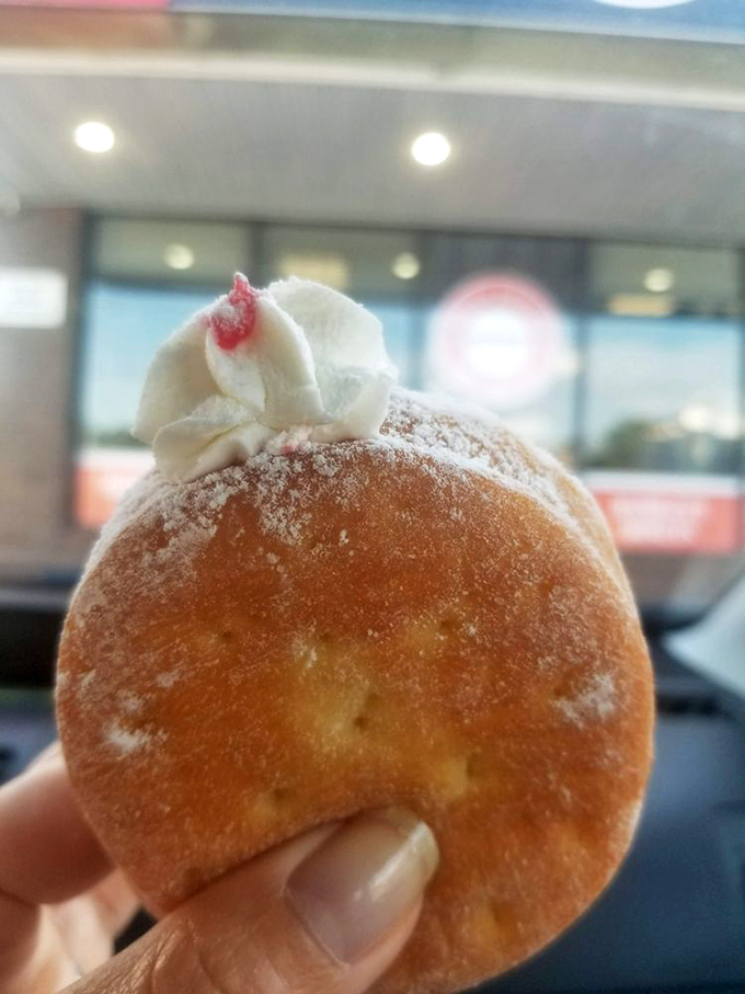 The powdered sugar dusting isn't just decoration&mdash;it's a promise. That dollop of cream and cherry hint at the sweet treasure waiting inside.