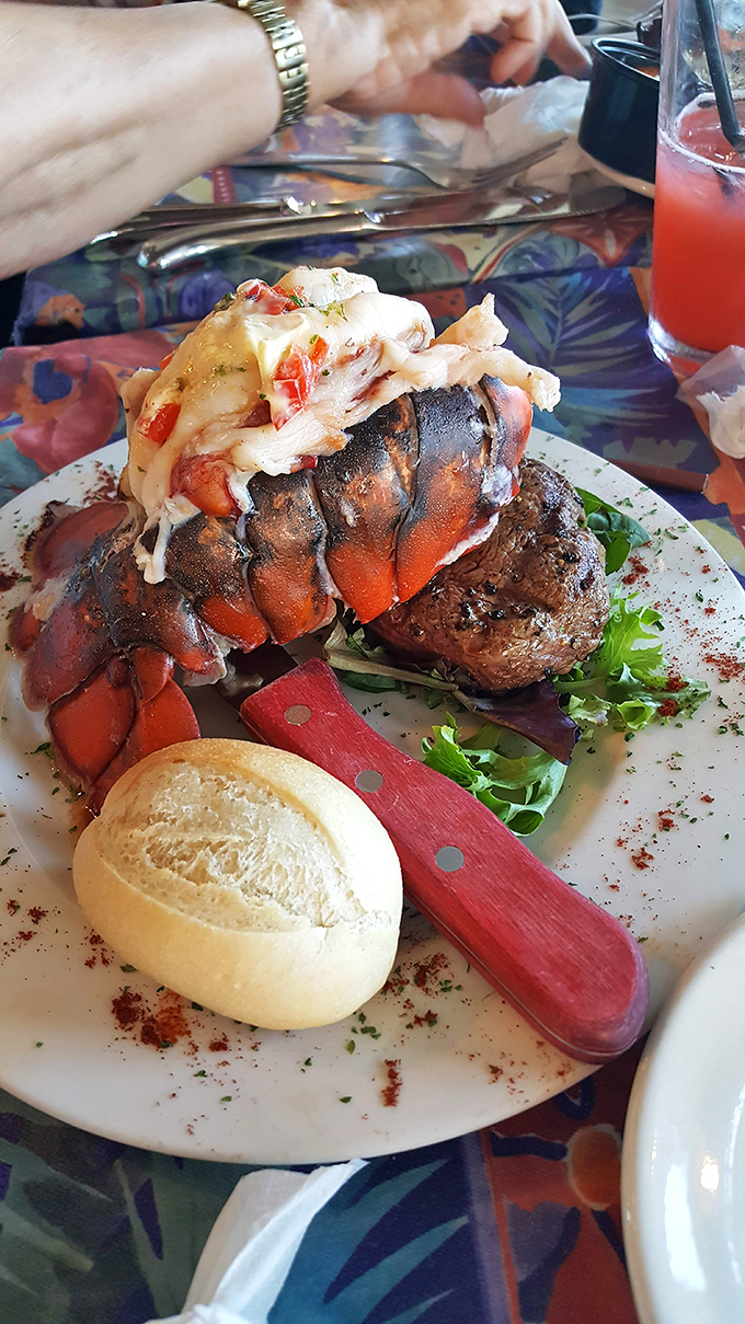 Surf meets turf in the ultimate beach romance: lobster tail and steak sharing a plate like they were made for each other.