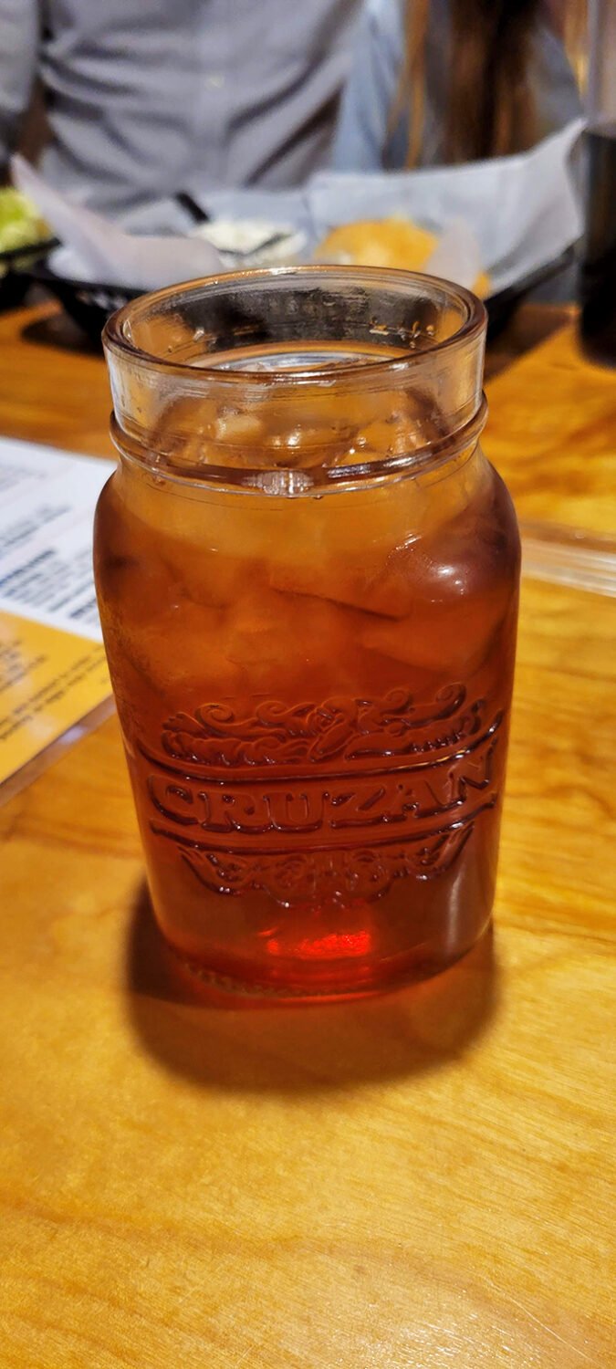 Sweet tea served in a mason jar &ndash; because in the South, proper hospitality means your tea glass should be bigger than your sandwich.