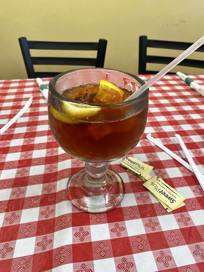 Sweet tea served in a goblet fit for royalty—because in Louisiana, proper hydration between bites of pasta is not optional, it's ceremonial.