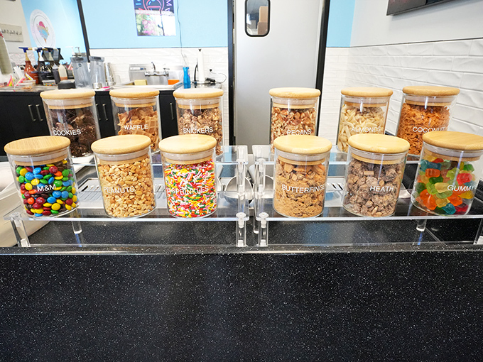 Topping jars lined up like soldiers ready for dessert duty. Each container holds the potential to transform good ice cream into an unforgettable experience.