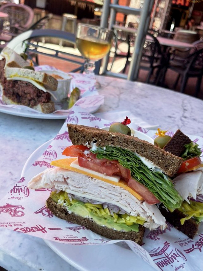 When a sandwich is served with this much care, eating becomes a sacred act. The fruit cup offers the illusion of health, but we all know why you're really here.