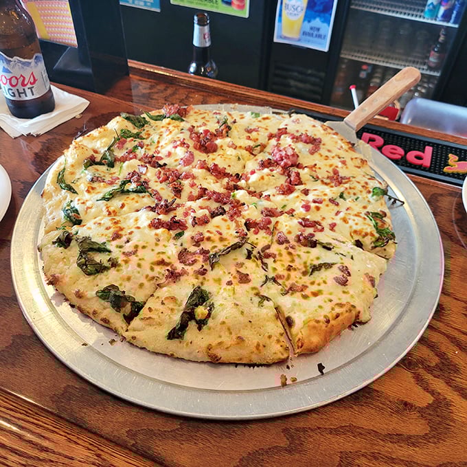 This white pizza with fresh greens is what happens when comfort food gets dressed up for a night out, but still keeps it real.