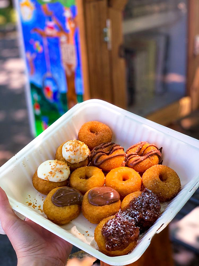 The to-go container might suggest "takeout," but good luck getting these honey-drizzled, chocolate-dipped, sugar-dusted delights home without sampling.
