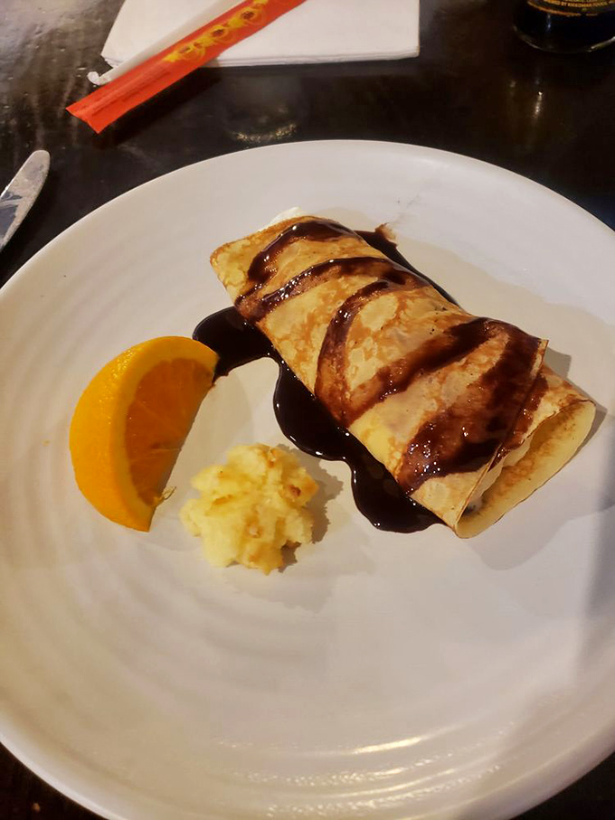 This isn't just a dessert&mdash;it's a banana crepe with chocolate drizzle that whispers, "You still have room for me." And somehow, miraculously, you do.