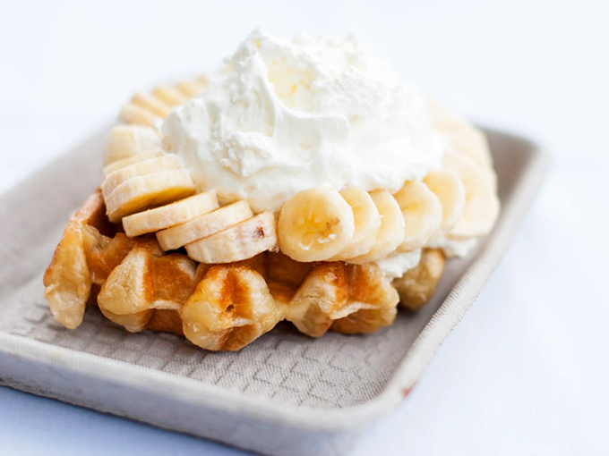 Bananas and whipped cream atop a golden waffle&mdash;proof that sometimes the simplest combinations yield the most profound happiness.