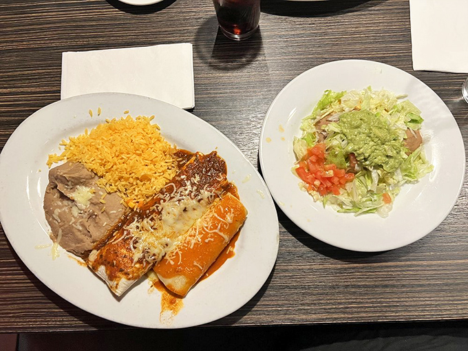 This enchilada plate with its vibrant rice and fresh sides proves that sometimes the simplest combinations create the most memorable meals.