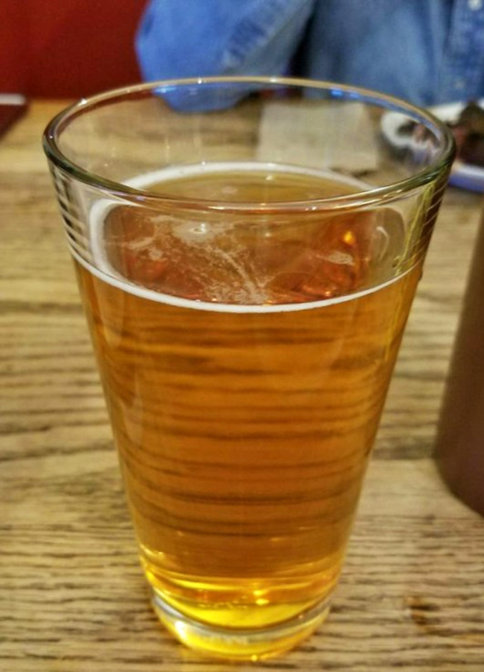 A cold beer at Woodyard isn't just a beverage&mdash;it's diplomatic intervention between your taste buds and the spicy barbecue heat. Liquid gold meets smoky perfection.