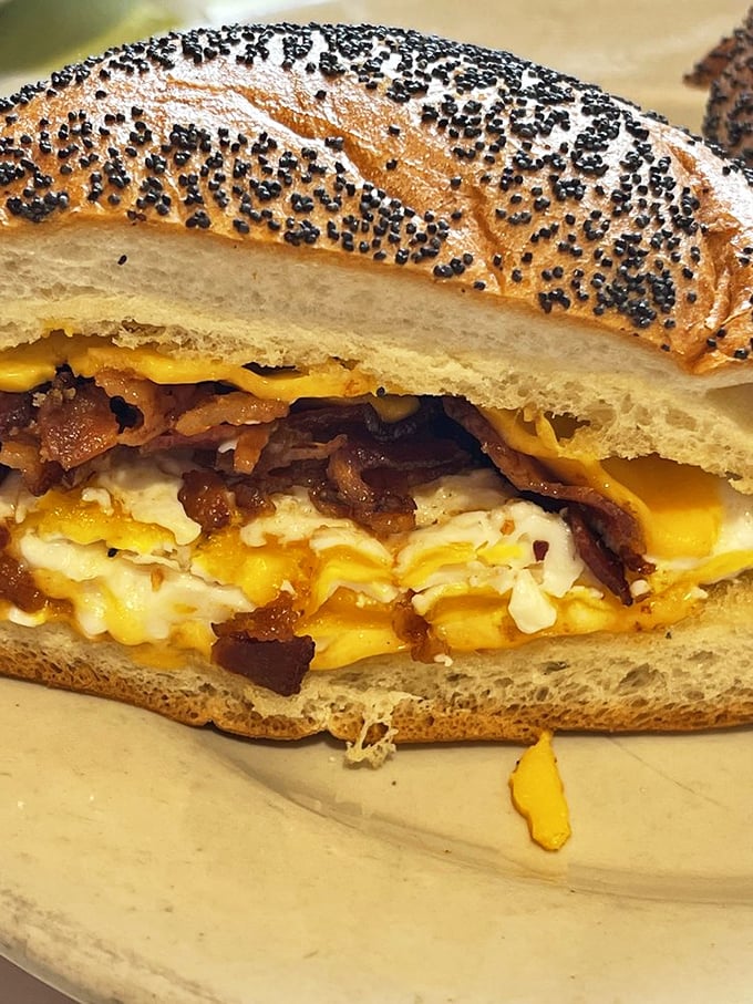 Breakfast meets art form with this poppy seed bagel sandwich, where eggs and bacon create a morning masterpiece worth setting an alarm for.