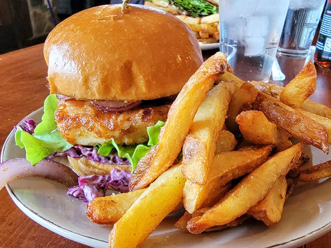 This isn't just a burger—it's a towering achievement of culinary engineering with hand-cut chips that could make a British expat weep with joy.