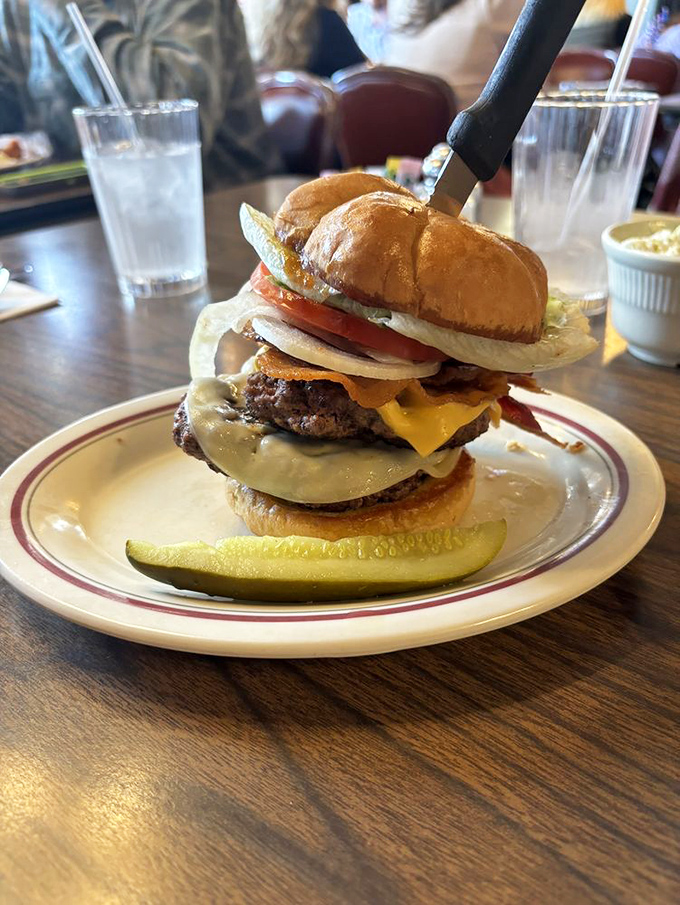 This isn't just a burger&mdash;it's an architectural achievement. The pickle stands guard like it knows it's part of something special.