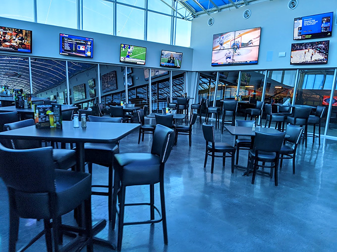 The dining area offers that perfect vantage point where you can simultaneously judge other drivers' techniques while pretending you could do better between bites.