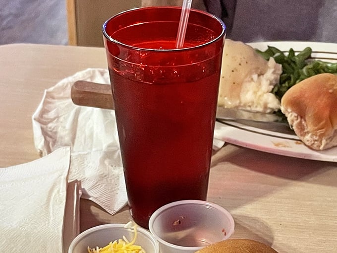 That ruby-red drink isn't just refreshment &ndash; it's the official beverage of "I'm taking my time with this meal because some pleasures shouldn't be rushed."