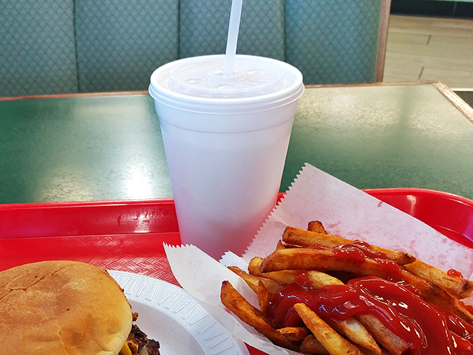 The holy trinity of American dining: a cold drink, hot fries with ketchup, and a burger that doesn't need a filter to look good.