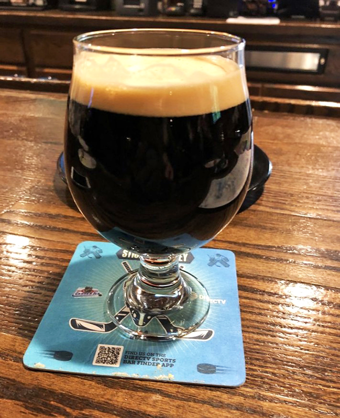 Dark as midnight and crowned with frothy perfection, this stout stands ready to help wash down burger challenges or humble dining defeats.