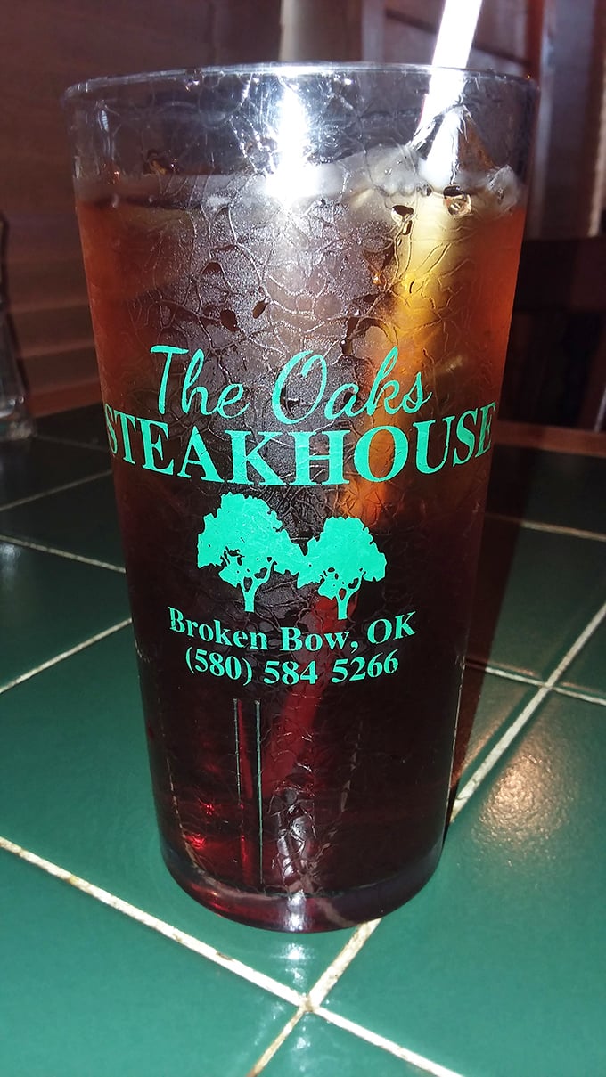 Their branded glass isn't just holding sweet tea&mdash;it's holding liquid Oklahoma. The condensation tells you it's properly cold, just like your grandmother would serve.