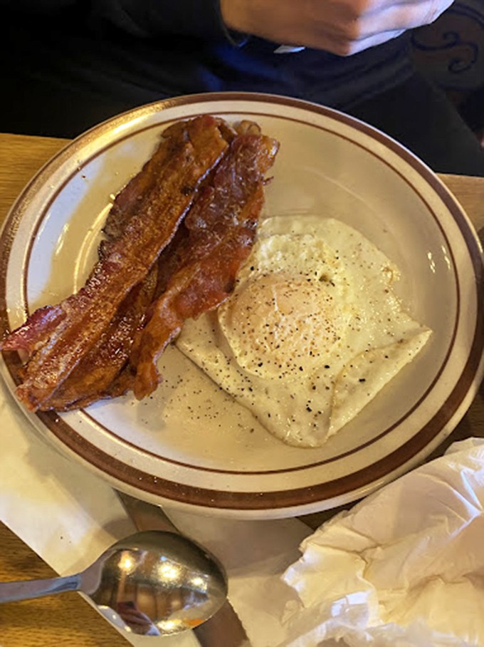 Sunny-side eggs with that perfect runny yolk and bacon cooked to that magical point between chewy and crisp. Morning perfection on a plate.