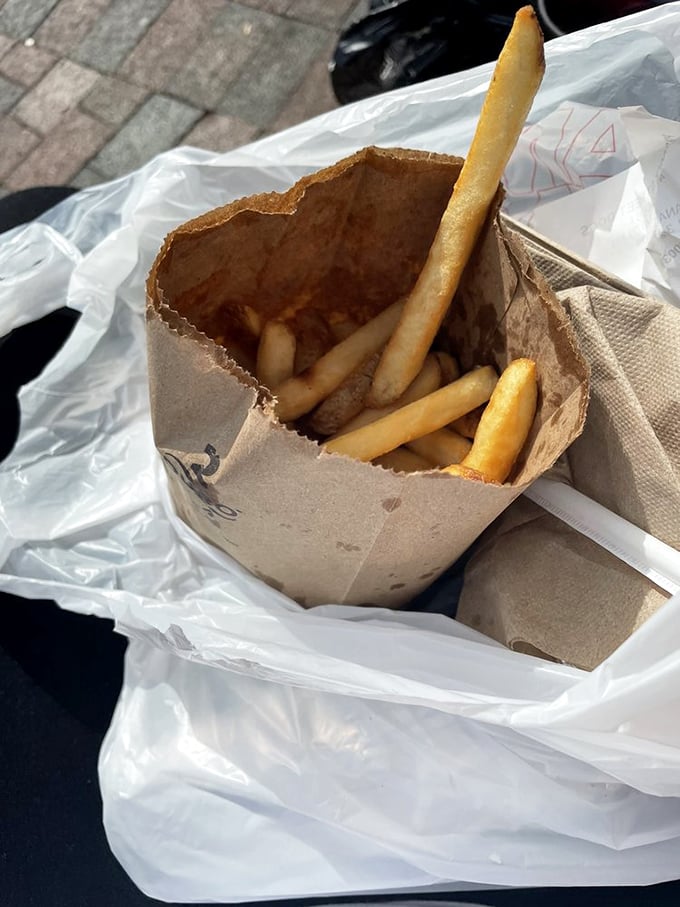 Crispy fries nestled in their foil-lined paper bag&mdash;the unsung heroes of any hot dog adventure and perfect for on-the-go exploring.