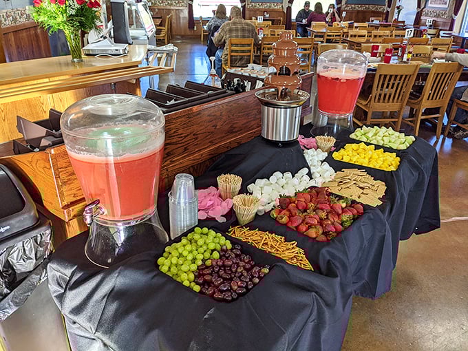 A refreshment station that understands the basic food groups: fruit, cheese, punch, and all the little extras that make gatherings memorable.