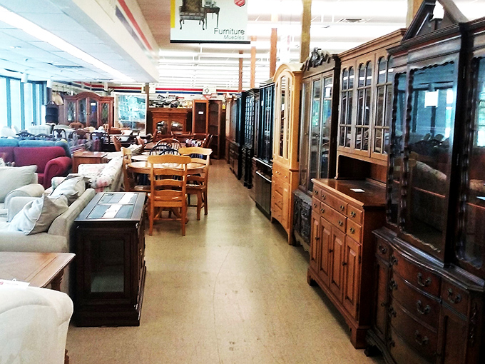 Furniture alley—where dining room sets and china cabinets stand like sentinels of domestic history, waiting for their second act.