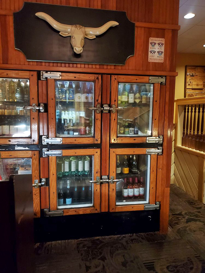 The steer silhouette above the vintage refrigerator case isn't just decoration&mdash;it's a promise of what awaits inside. Bovine paradise.