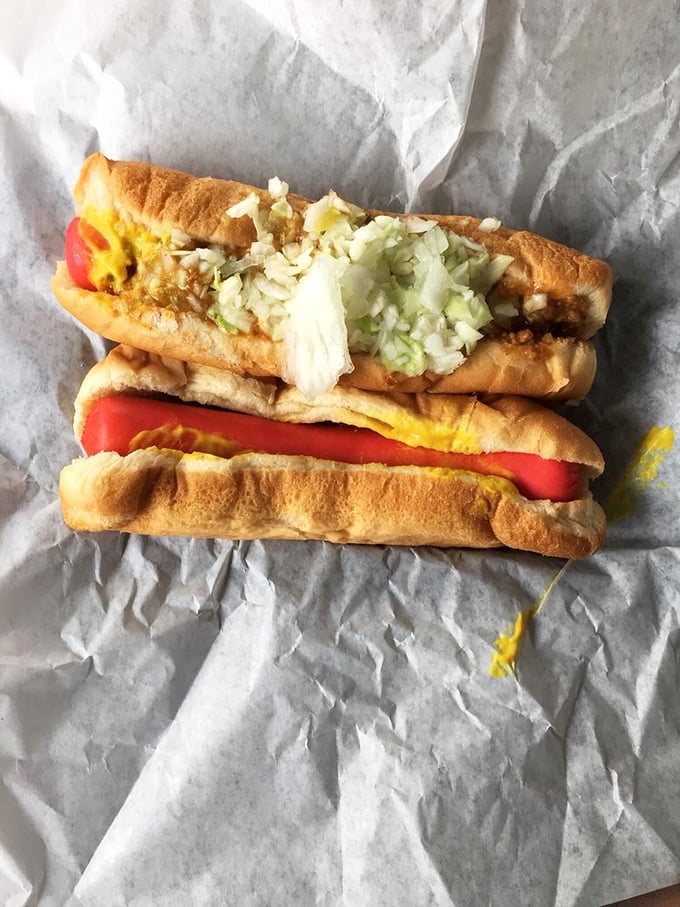 Poetry on a bun! The careful layering of mustard, chili, and fresh onions creates the textbook definition of hot dog harmony.