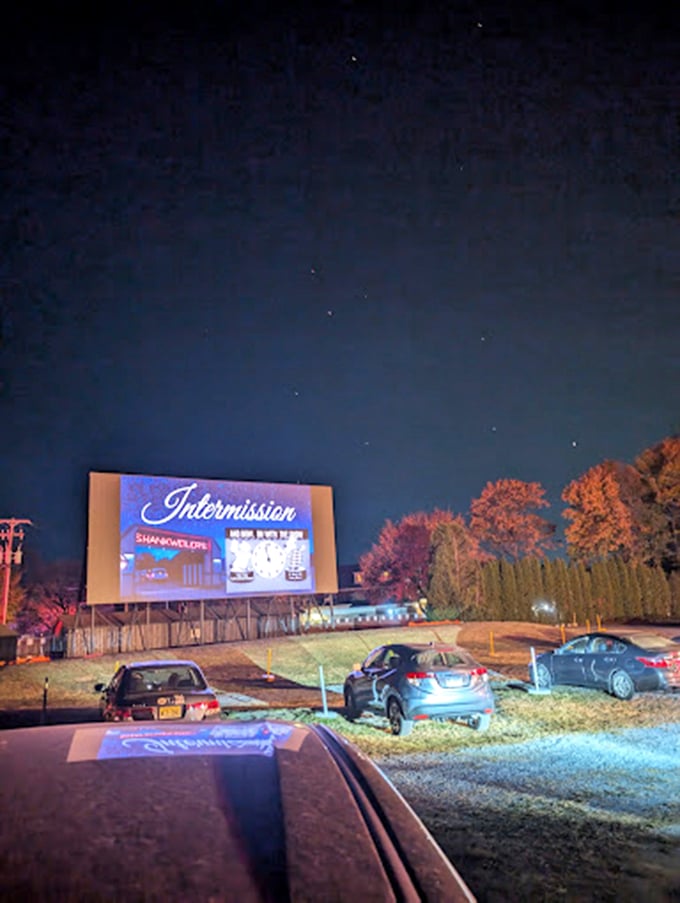 The iconic red "SHANKWEILER'S" sign glows like a beacon at sunset, guiding movie lovers to their evening escape from reality. 