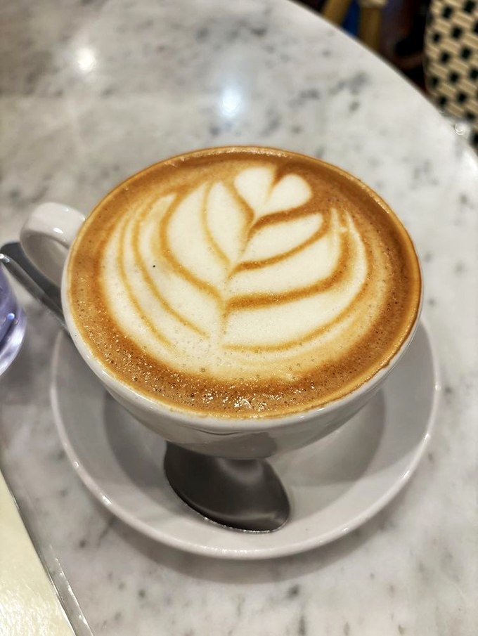 Latte art so pretty you almost don't want to drink it. Almost. That marble table isn't just for looks &ndash; it's for Instagram domination.